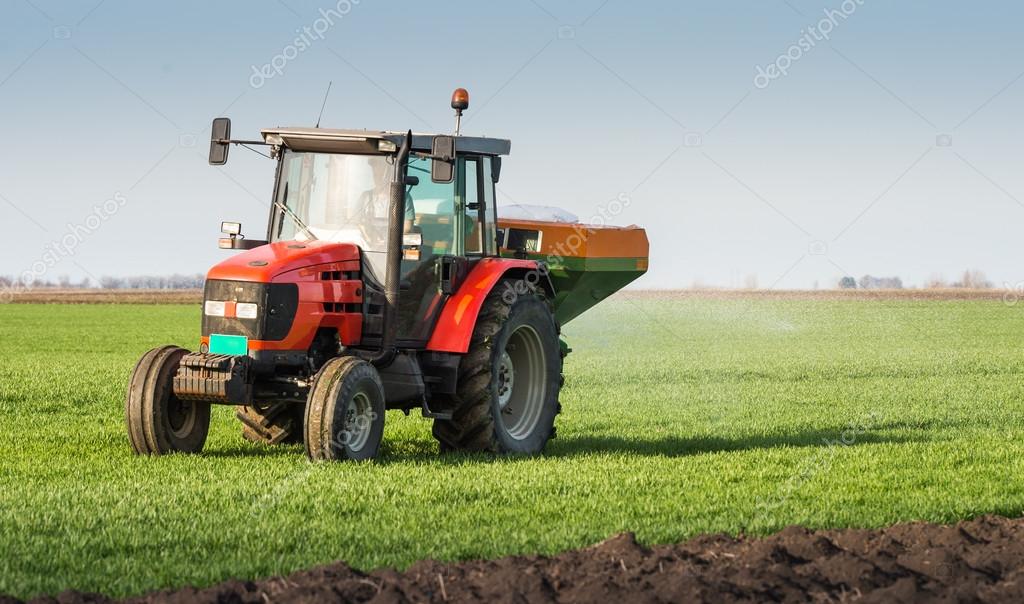 Tractor fertilizing in field — Stock Photo © fotokostic #100355552