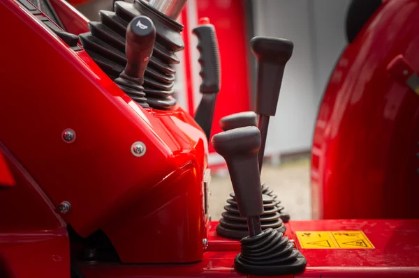 Gearbox stick on red tractor - Stock Image - Everypixel
