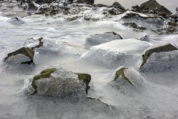 Ice splashes on frozen rocks and stones Stock Photos, Royalty Free Ice ...