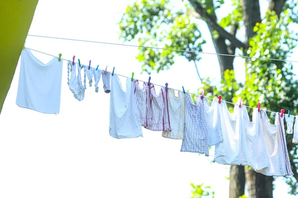 Laundry line with falling clothes on a white background Stock Photo by ...