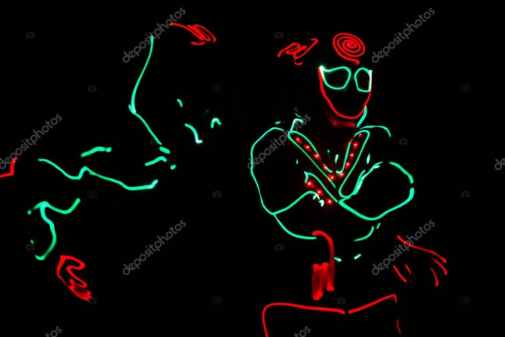 Dancers crew in led suits on dark background, colored show Stock Photo ...