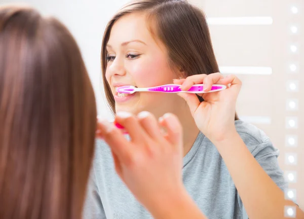 Happy woman cleaning teeth with toothbrush — Stock Photo © valuavitaly ...