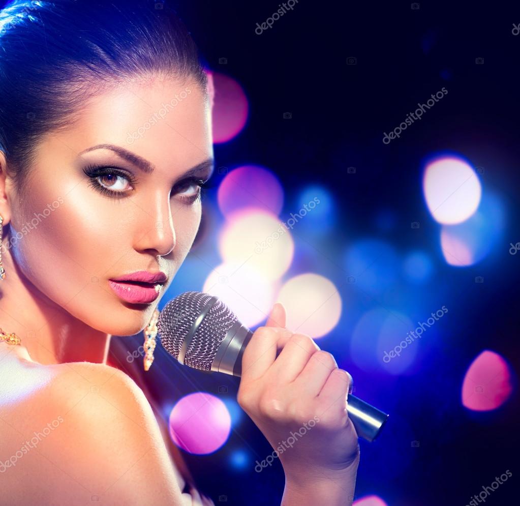 Woman with microphone over night background — Stock Photo © Subbotina ...