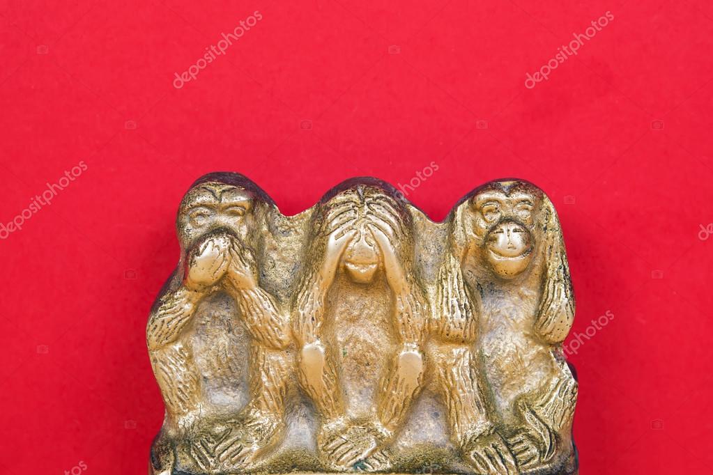 Brass statue of three monkeys isolated on wooden surface. — Stock Photo ...