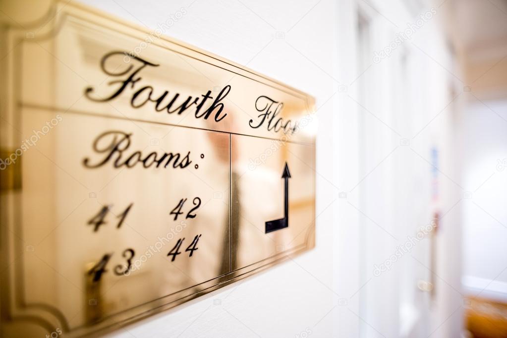 Hotel signs directions on a wall — Stock Photo © stockyimages #77514164