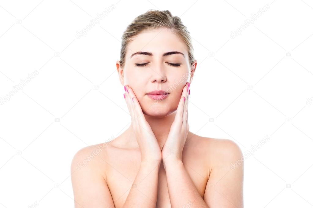 Woman applying body lotion on face — Stock Photo © stockyimages #81620764