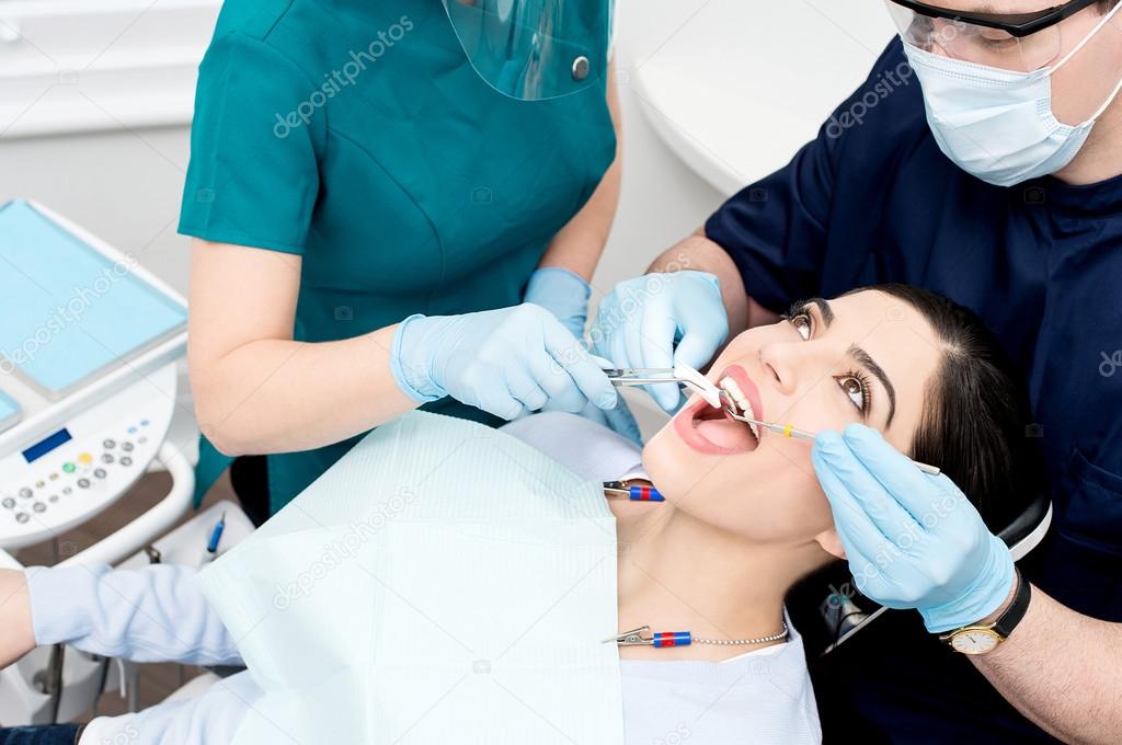 Patient receiving treatment from dentist — Stock Photo © stockyimages ...