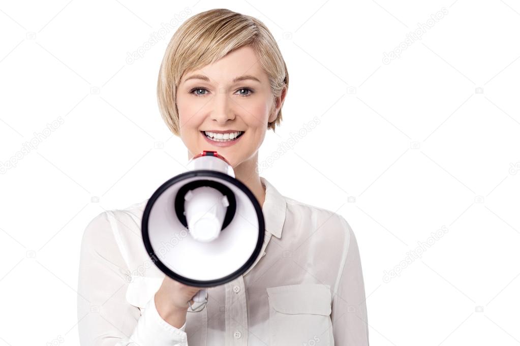 Woman making announcement via loudspeaker Stock Photo by ©stockyimages ...