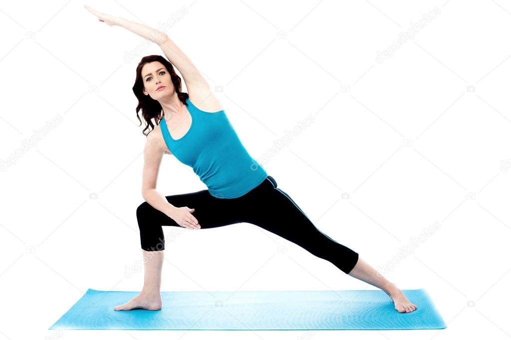 Woman doing side stretch exercise — Stock Photo © stockyimages #94203964