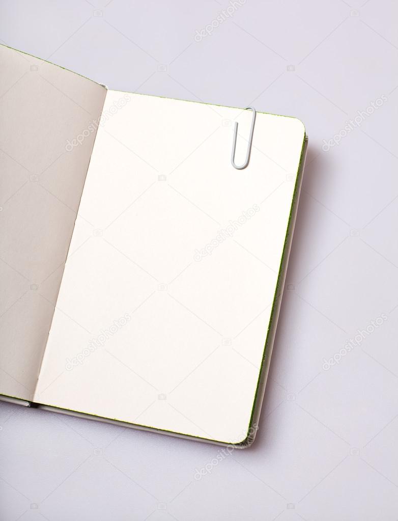 Open notepad blank page on white table Stock Photo by ©ollzha 60513937