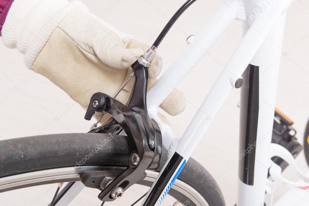 Hand adjusting brakes — Stock Photo © Amaviael #103344204