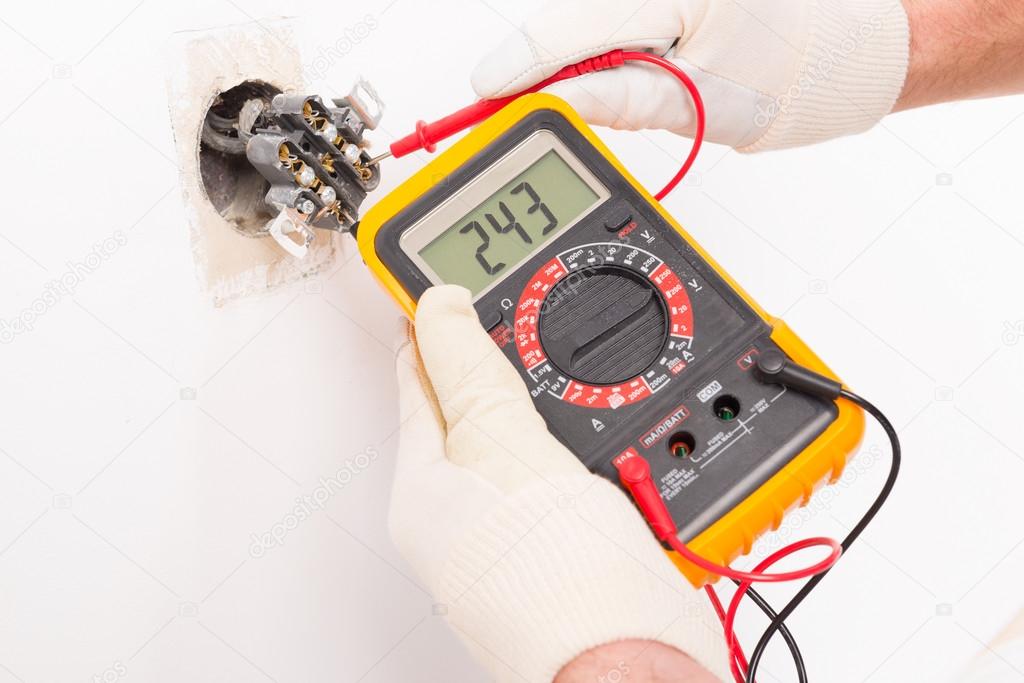 Electrician checking socket Stock Photo by ©Amaviael 68393603