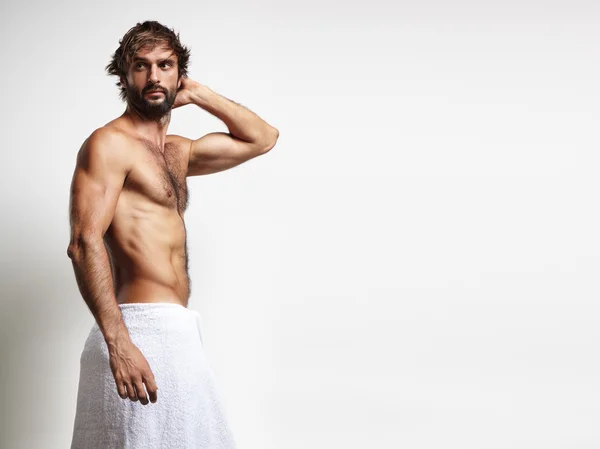Strong man in towel Stock Photo by ©kazzakova 58937515