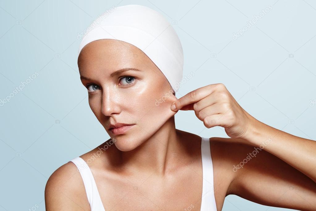 Woman pinched skin on face Stock Photo by ©kazzakova 74829759
