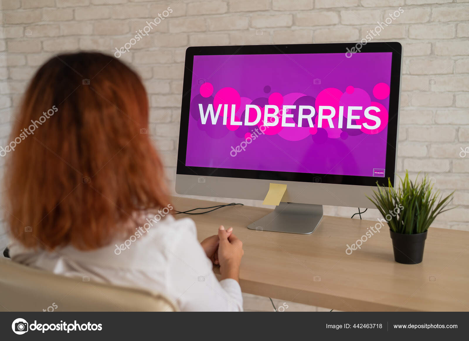 16.09.2020 Russian, Novosibirsk: Woman sitting in front of computer withwildberries logo on ...