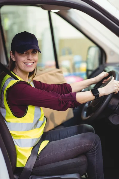 Delivery driver driving van with parcels on seat - Stock Image - Everypixel