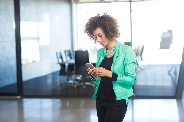 Woman using phone in office - Stock Image - Everypixel