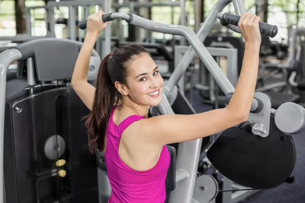 Fit woman using weight machine - Stock Image - Everypixel