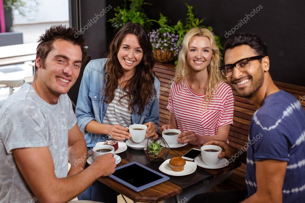 Friends enjoying coffee together Stock Photo by ©Wavebreakmedia 101085626 Friends enjoying coffee together Stock Photo by ©Wavebreakmedia 101085626
