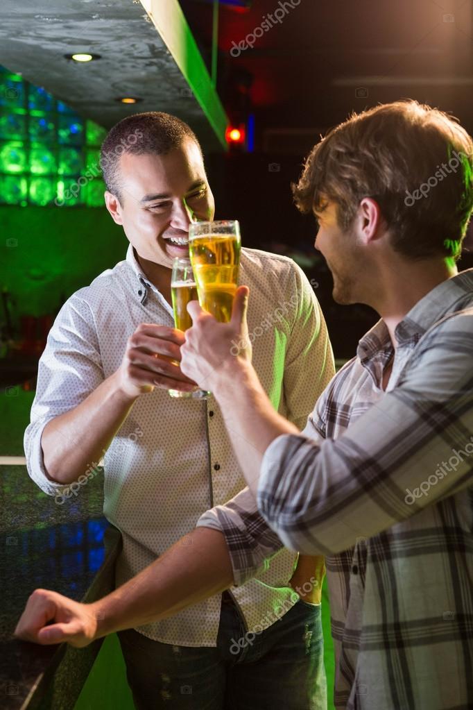 Two men toasting with glass of beer Stock Photo by ©Wavebreakmedia ...