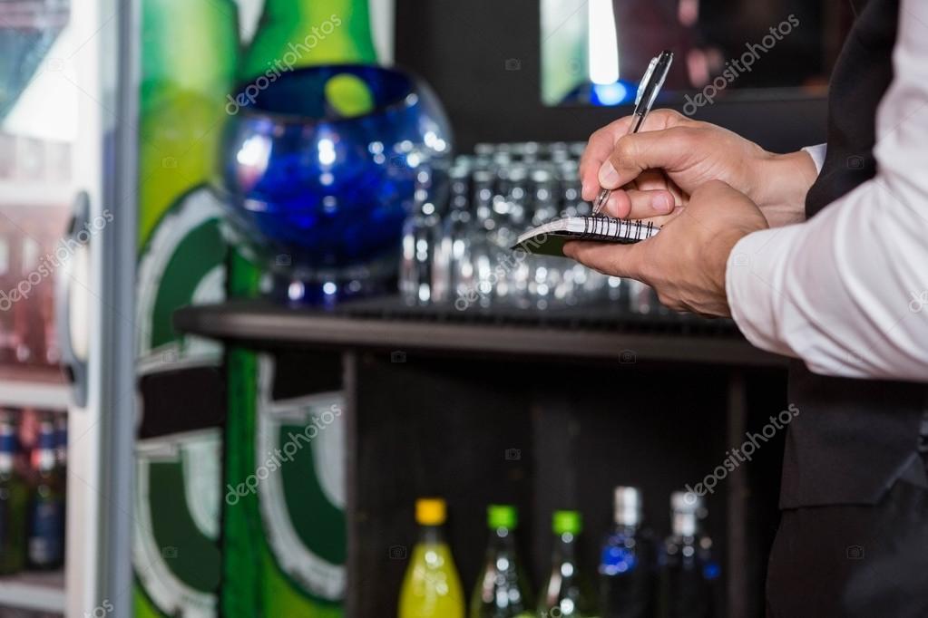 Waiter writing down an order Stock Photo by ©Wavebreakmedia 101502826