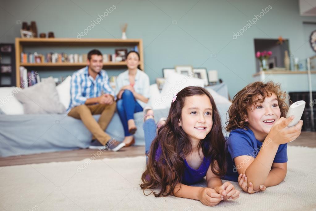 Happy children with remote Stock Photo by ©Wavebreakmedia 102313296