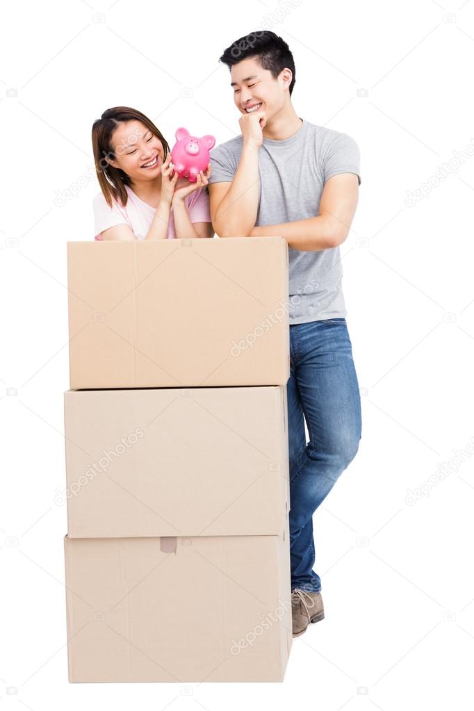 Couple leaning on cardboard boxes Stock Photo by ©Wavebreakmedia 102611108