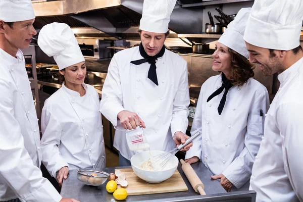 chef teaching team to prepare dough - Stock Image - Everypixel