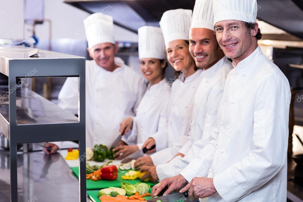 Team of chefs chopping vegetables Stock Photo by ©Wavebreakmedia 103303046