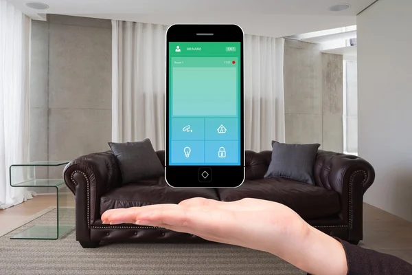 Hand showing home automation on phone - Stock Image - Everypixel