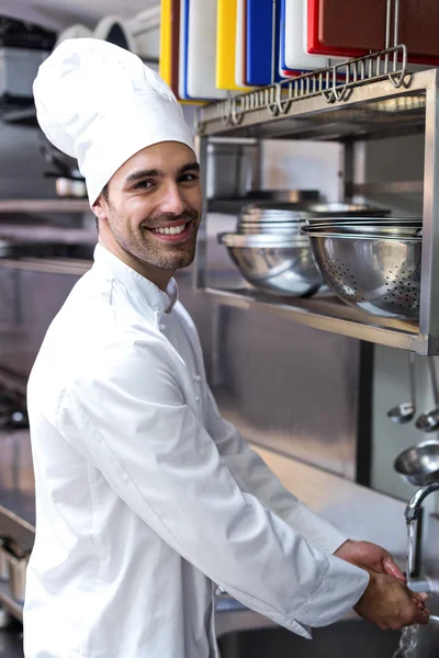 Handsome chef washing his hands Stock Photo by ©Wavebreakmedia 104753454