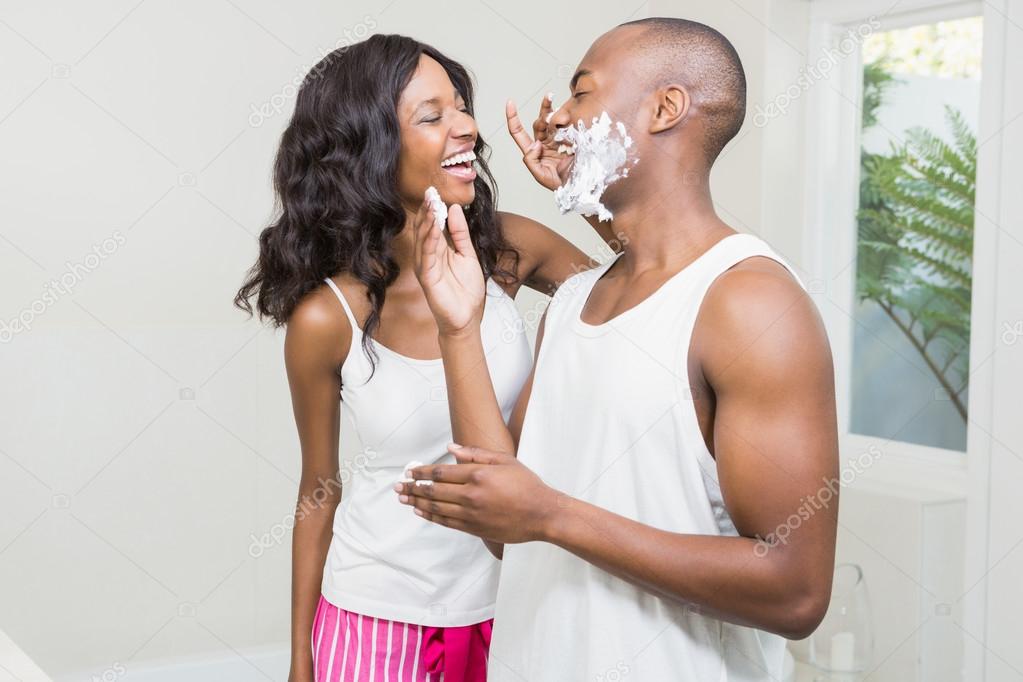 Woman applying shaving cream on mans face — Stock Photo © Wavebreakmedia #106119022