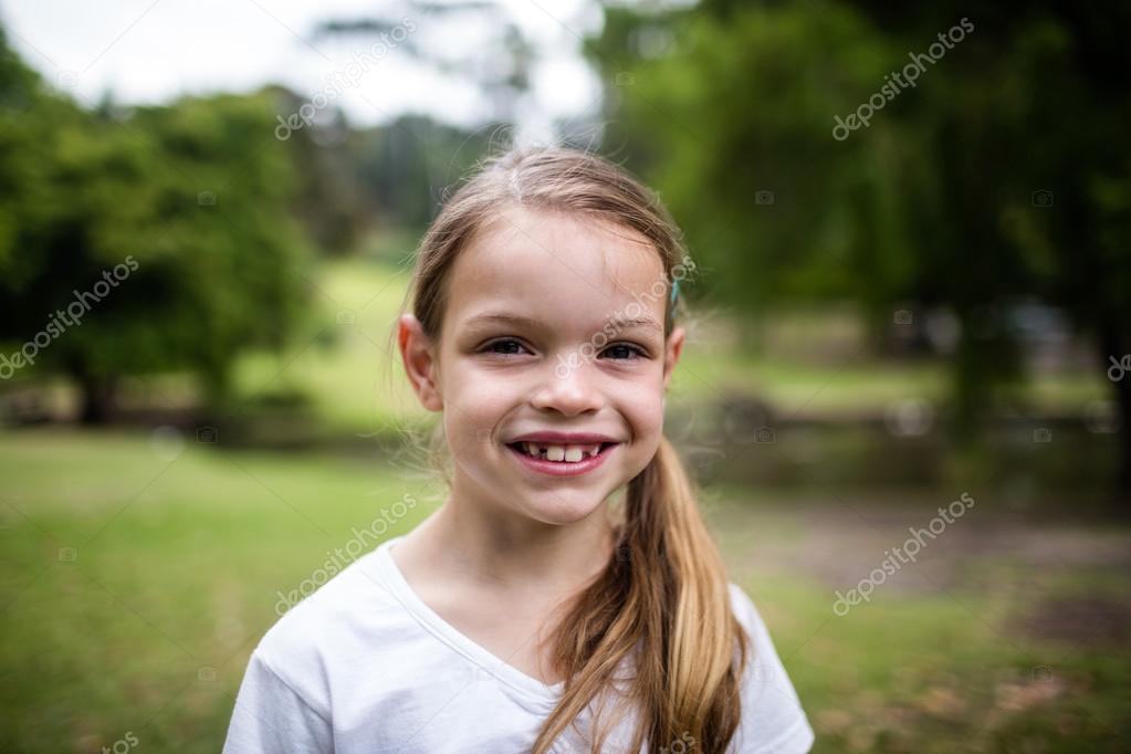 Girl smiling in park Stock Photo by ©Wavebreakmedia 106123426