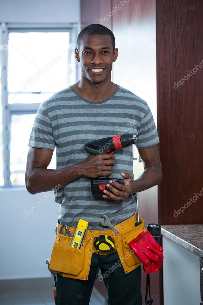 Manual worker holding drill machine Stock Photo by ©Wavebreakmedia ...