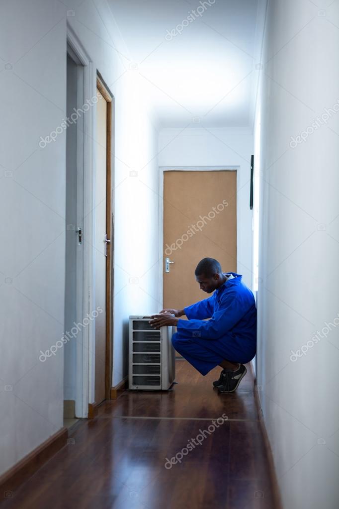 Handyman testing air conditioner — Stock Photo © Wavebreakmedia #106128914