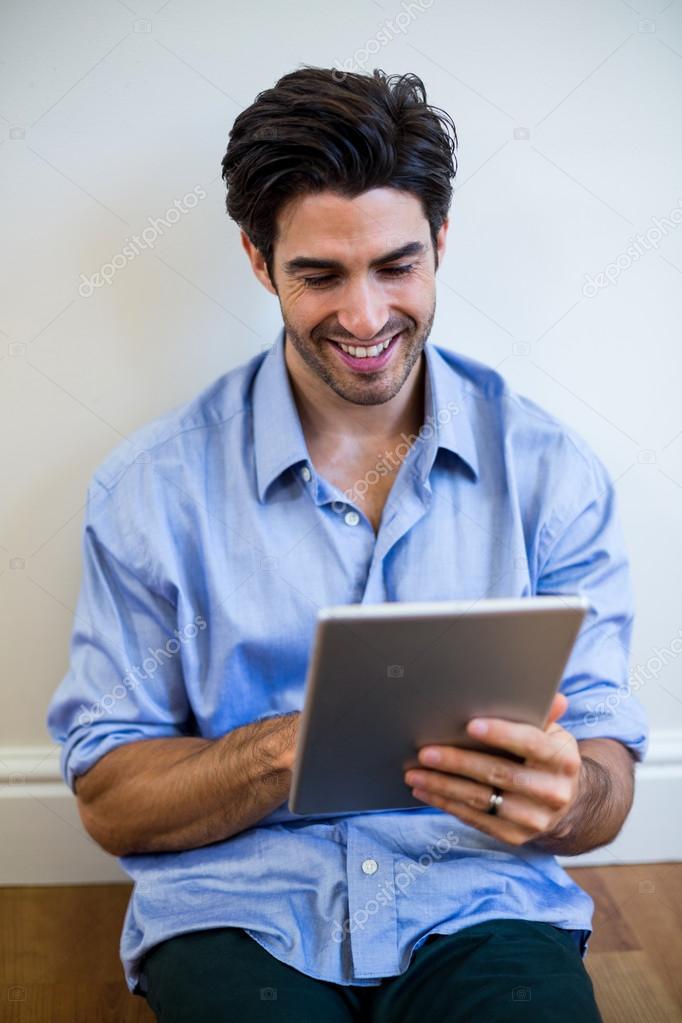 Man on floor using tablet — Stock Photo © Wavebreakmedia #106164622