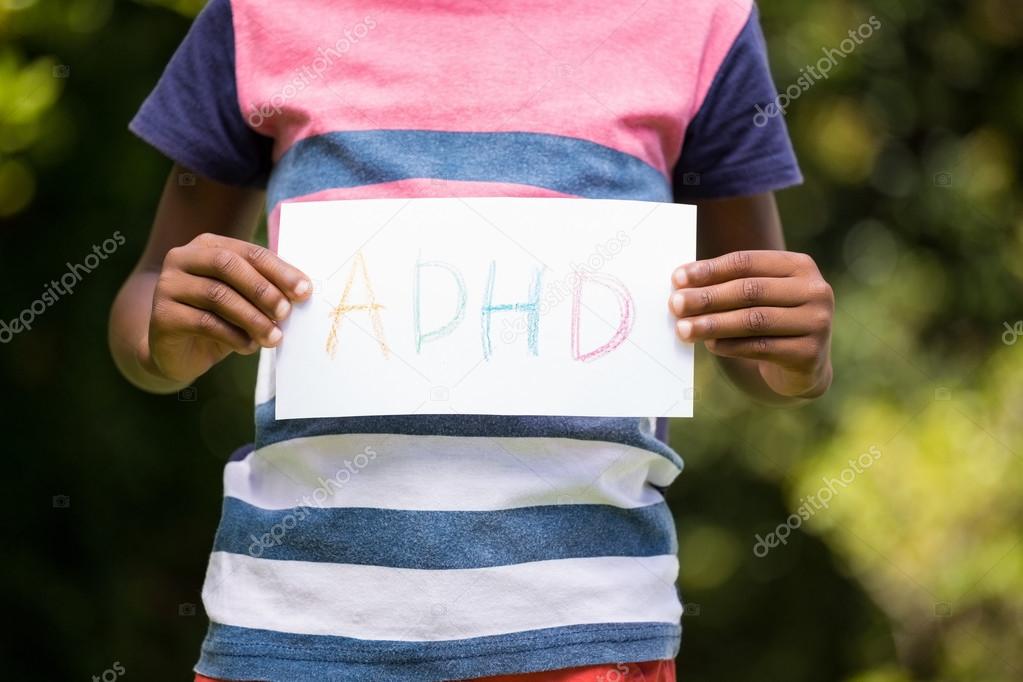 Boy showing a poster with ADHD Stock Photo by ©Wavebreakmedia 108972144