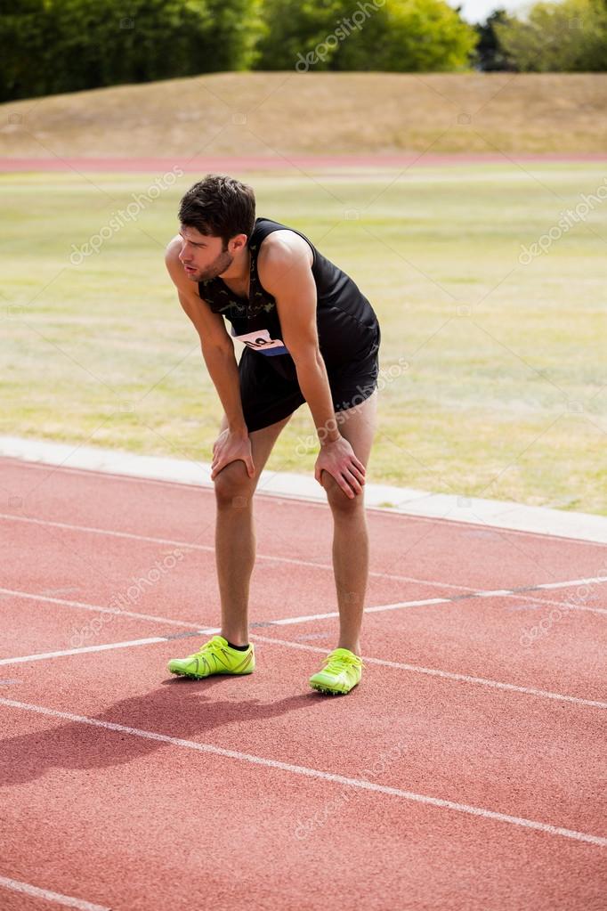 Tired athlete on running track Stock Photo by ©Wavebreakmedia 110791220