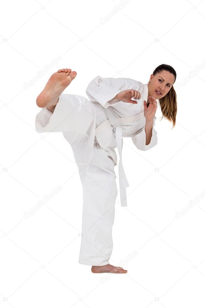 Fighter performing karate stance Stock Photo by ©Wavebreakmedia 110797816