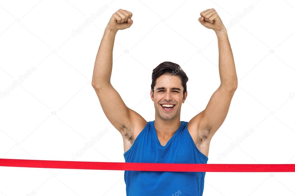 Portrait of cheerful winner athlete crossing finish line Stock Photo by ...