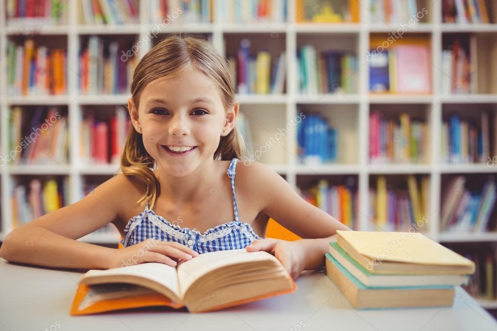 School girl reading book in library — Stock Photo © Wavebreakmedia ...