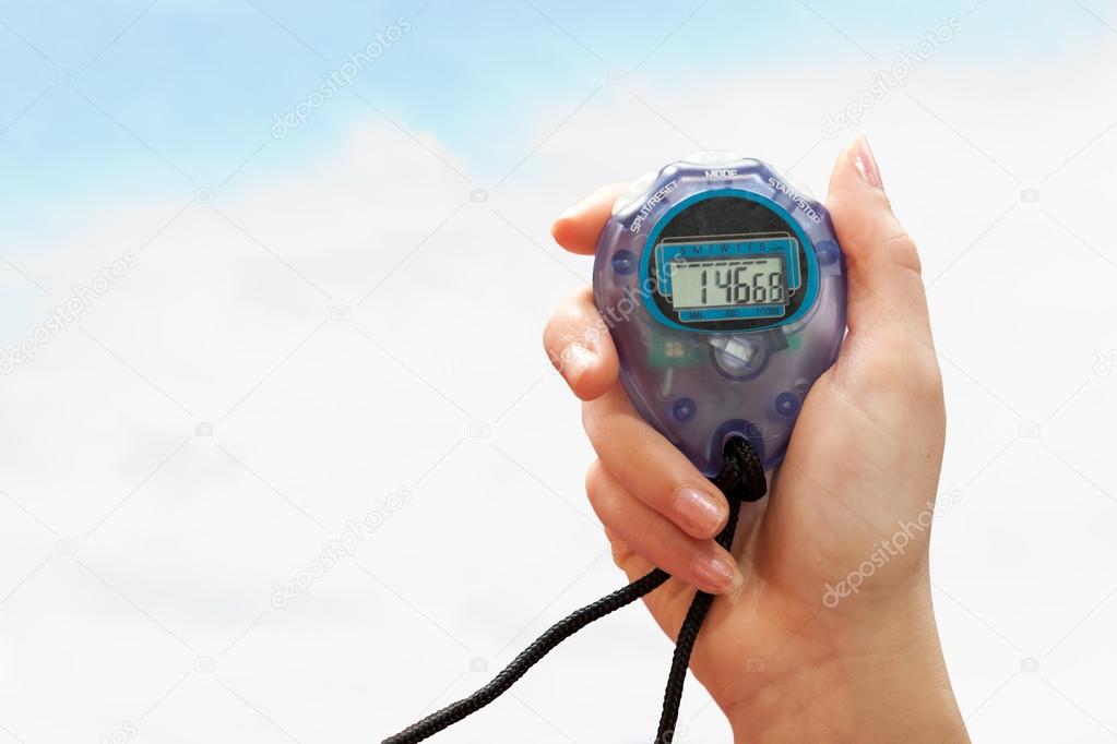 Hand holding timer on white Stock Photo by ©Wavebreakmedia 113550366