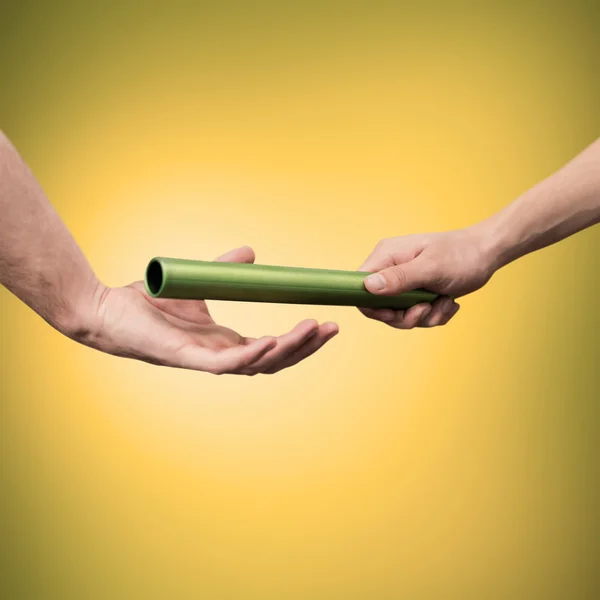 Athlete passing baton to partner Stock Photo by ©Wavebreakmedia 113542982