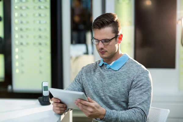 Customer using digital tablet in optical store - Stock Image - Everypixel