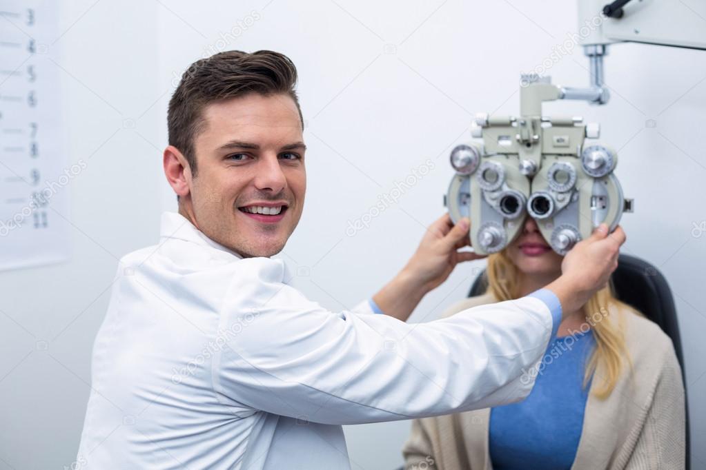 Smiling optometrist examining female patient on phoropter ⬇ Stock Photo ... Smiling optometrist examining female patient on phoropter ⬇ Stock Photo ...
