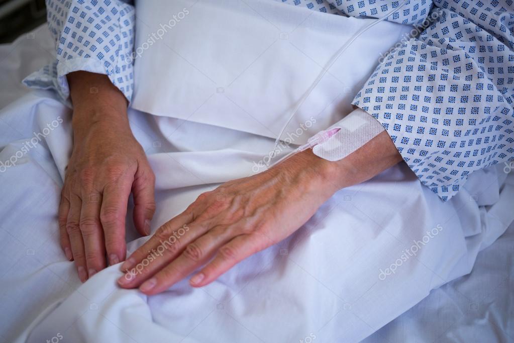Patients hand with iv drip — Stock Photo © Wavebreakmedia #123951250