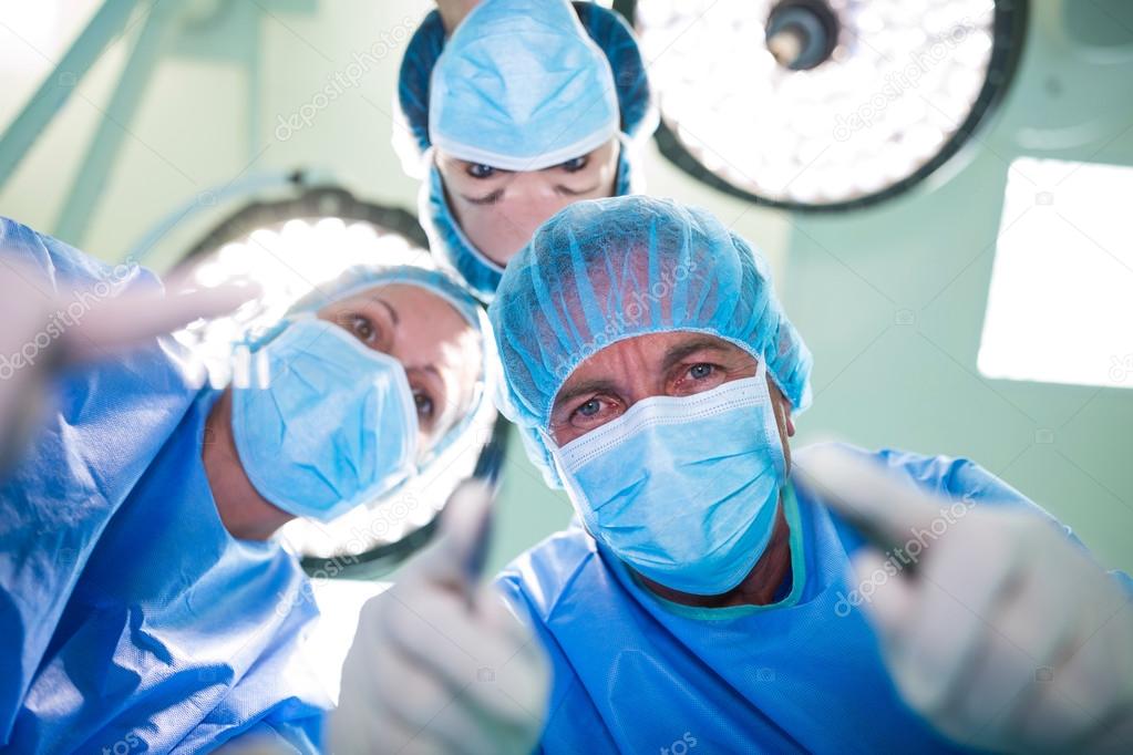 Surgeons performing operation in operation room Stock Photo by ...