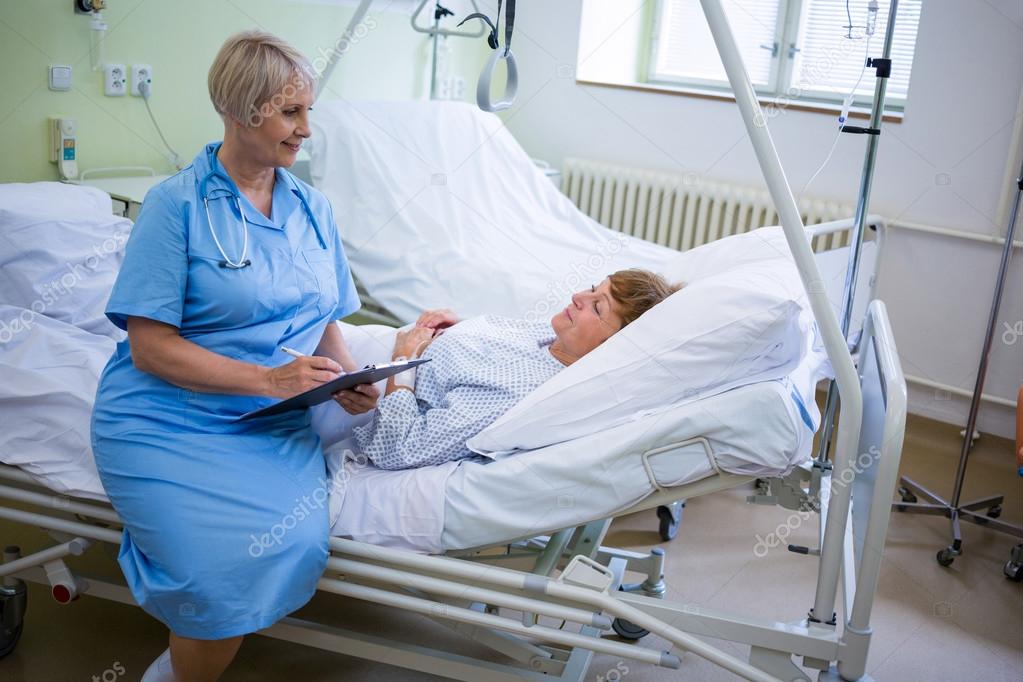 Nurse interacting with a patient Stock Photo by ©Wavebreakmedia 123952692