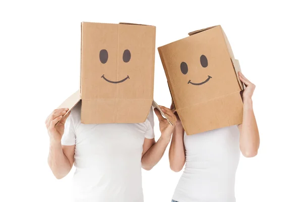 Couple wearing smiley face boxes on their heads — Stock Photo ...