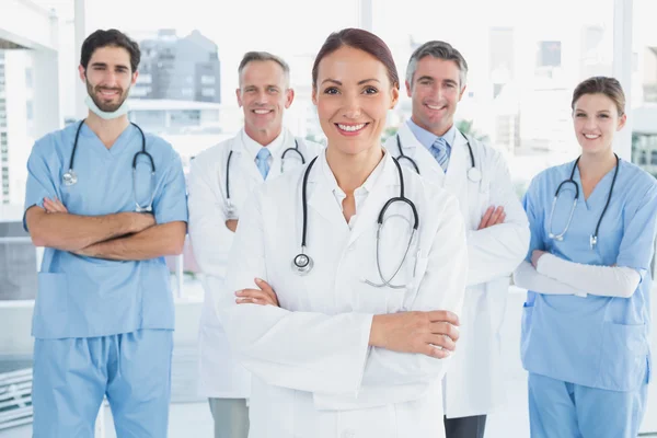 Smiling doctor with fellow doctors - Stock Image - Everypixel